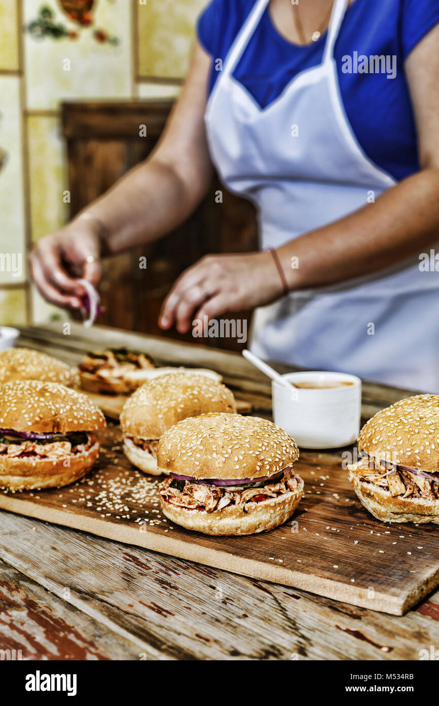 Home cooking. A woman is cooking burgers Stock Photo - Alamy