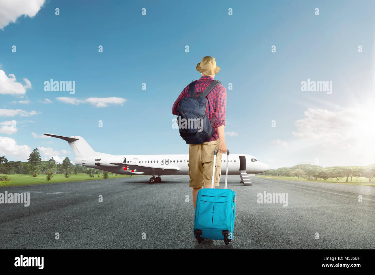 Back view of asian traveler man walking with suitcase to airplane in ...