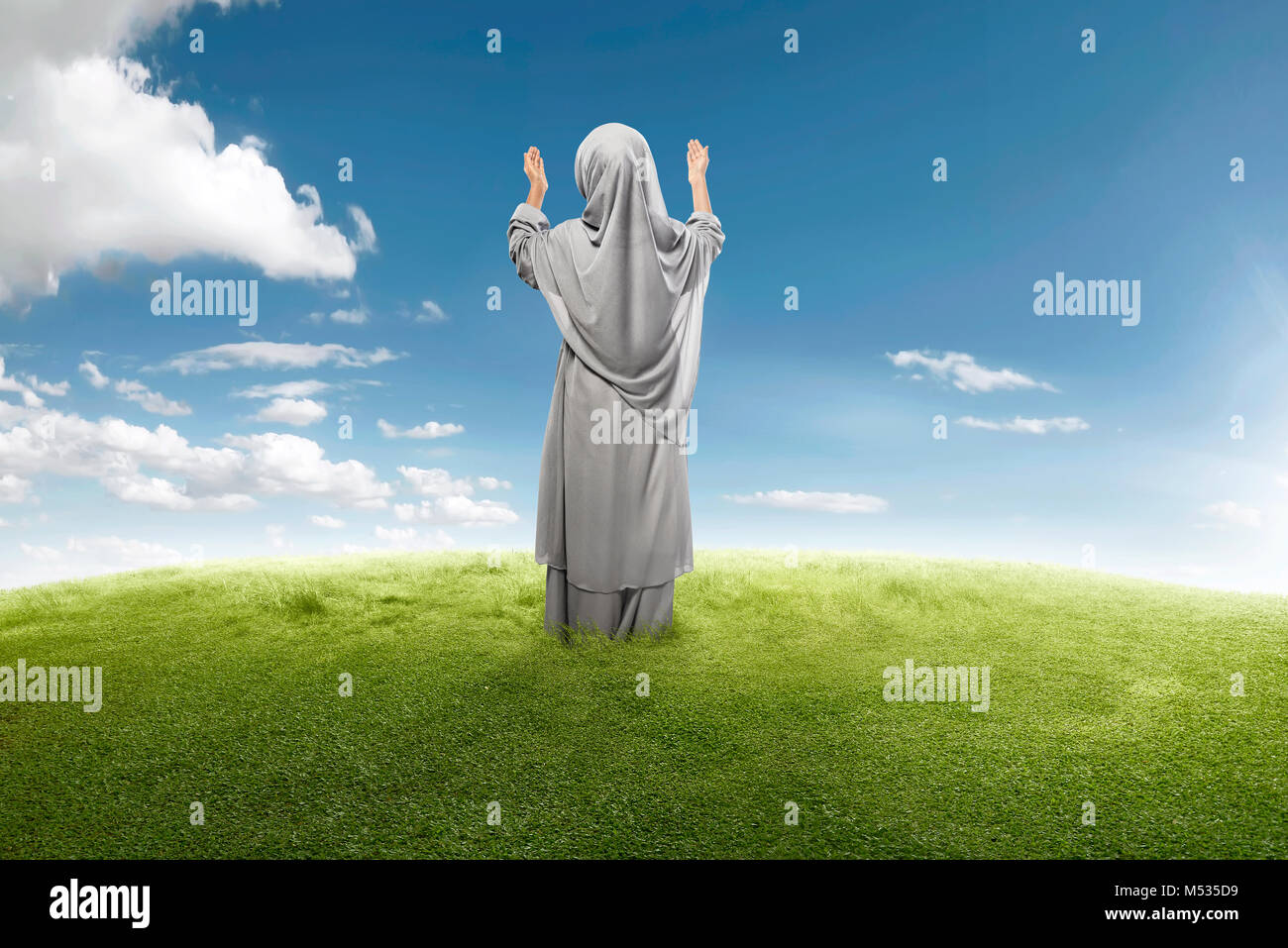 Back view of asian muslim girl praying to god on green meadow Stock ...