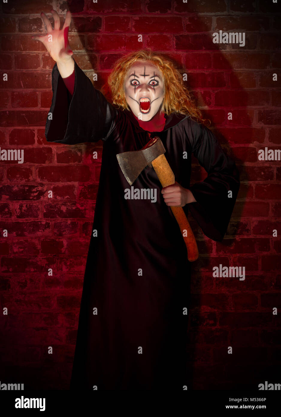 Scary witch on brick background Stock Photo - Alamy
