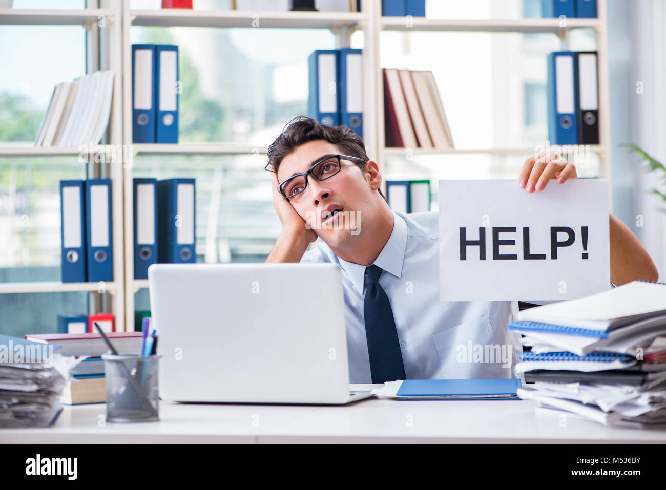 Young businessman asking for help in office Stock Photo - Alamy