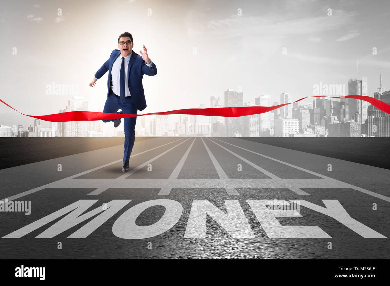 Businessman running towards money on track Stock Photo - Alamy