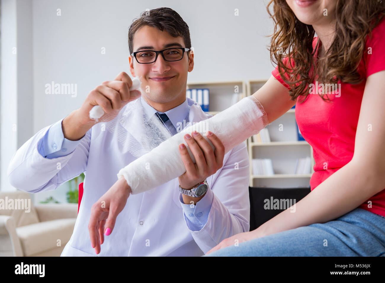 Doctor and patient during check-up for injury in hospital Stock Photo ...