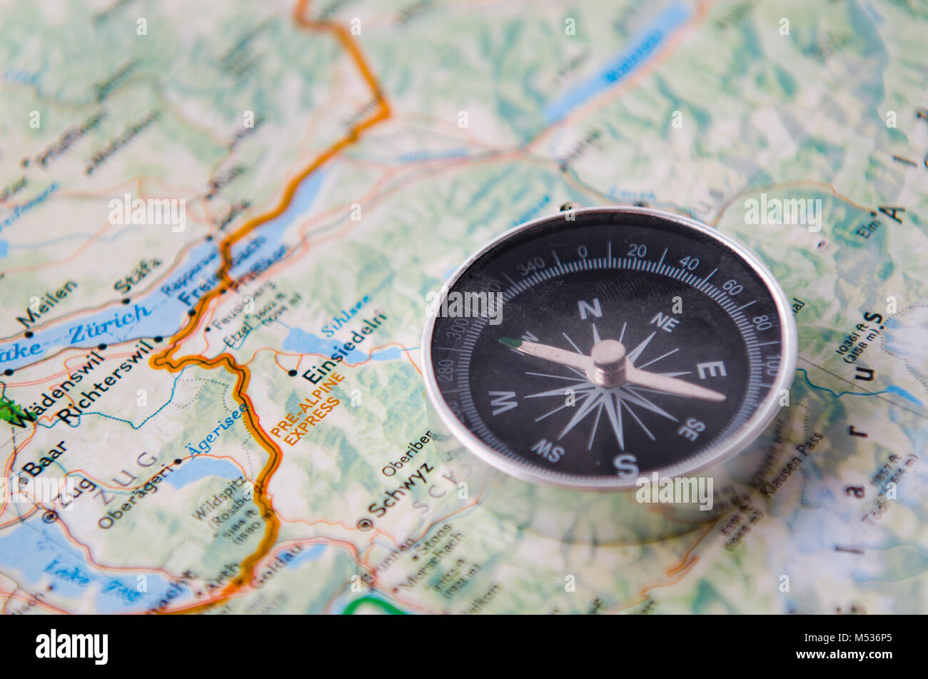 Travel concept with compass and map Stock Photo - Alamy