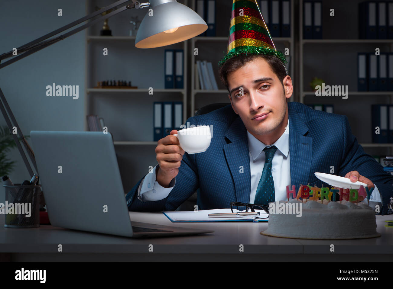 Man celebrating birthday in the office Stock Photo - Alamy
