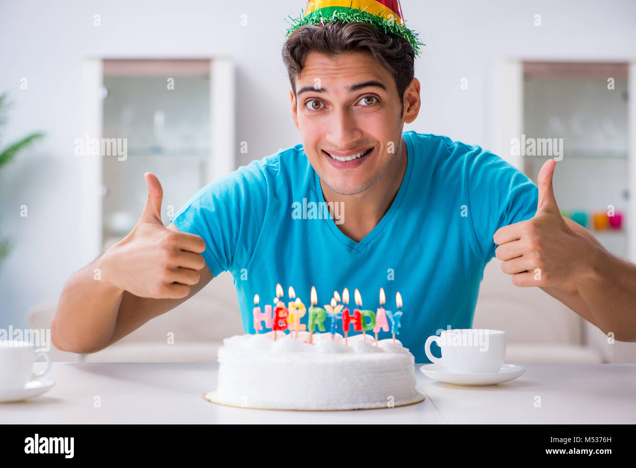 Young man celebrating birthday alone at home Stock Photo - Alamy