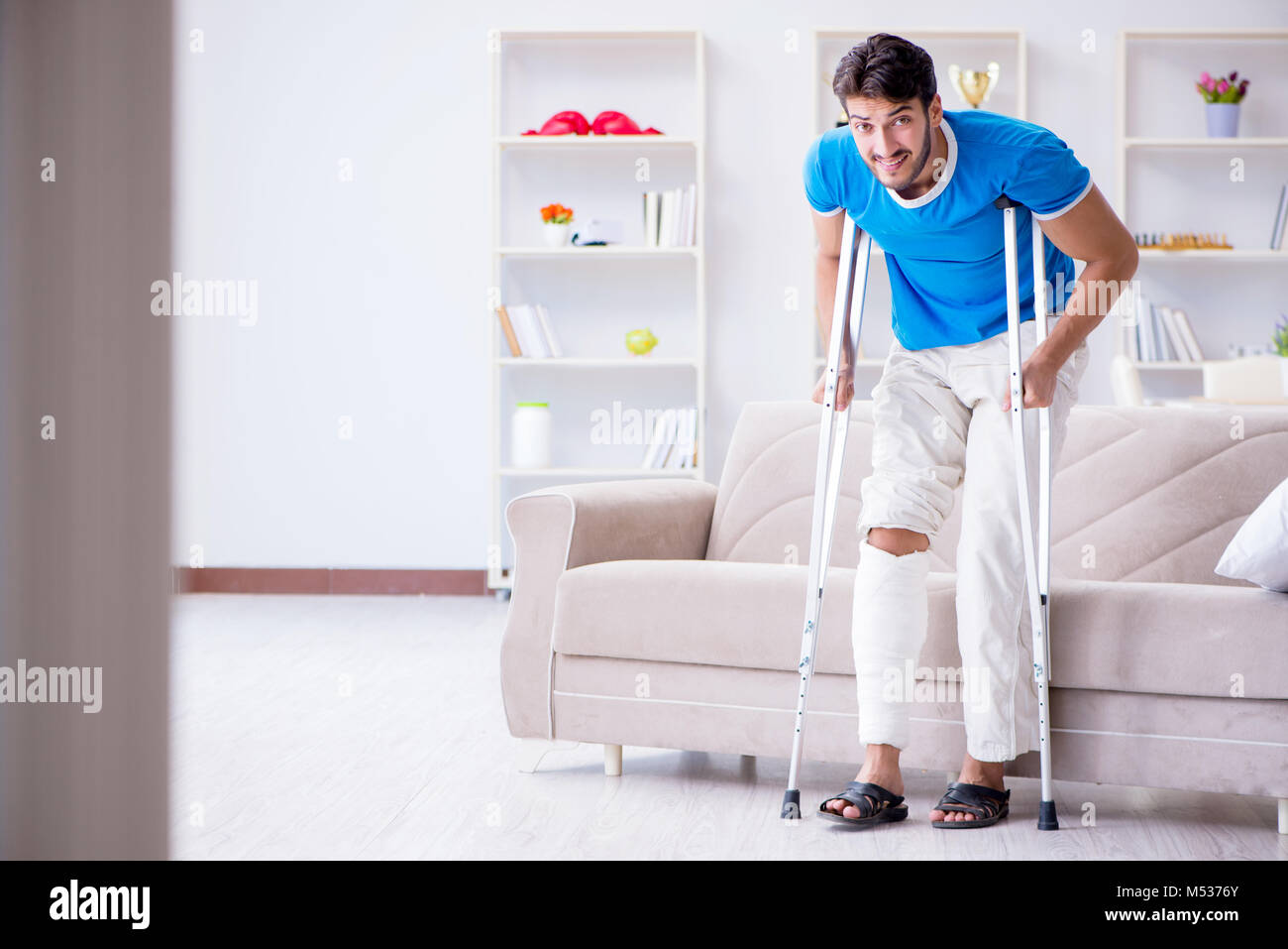 Injured young man recovering at home Stock Photo - Alamy