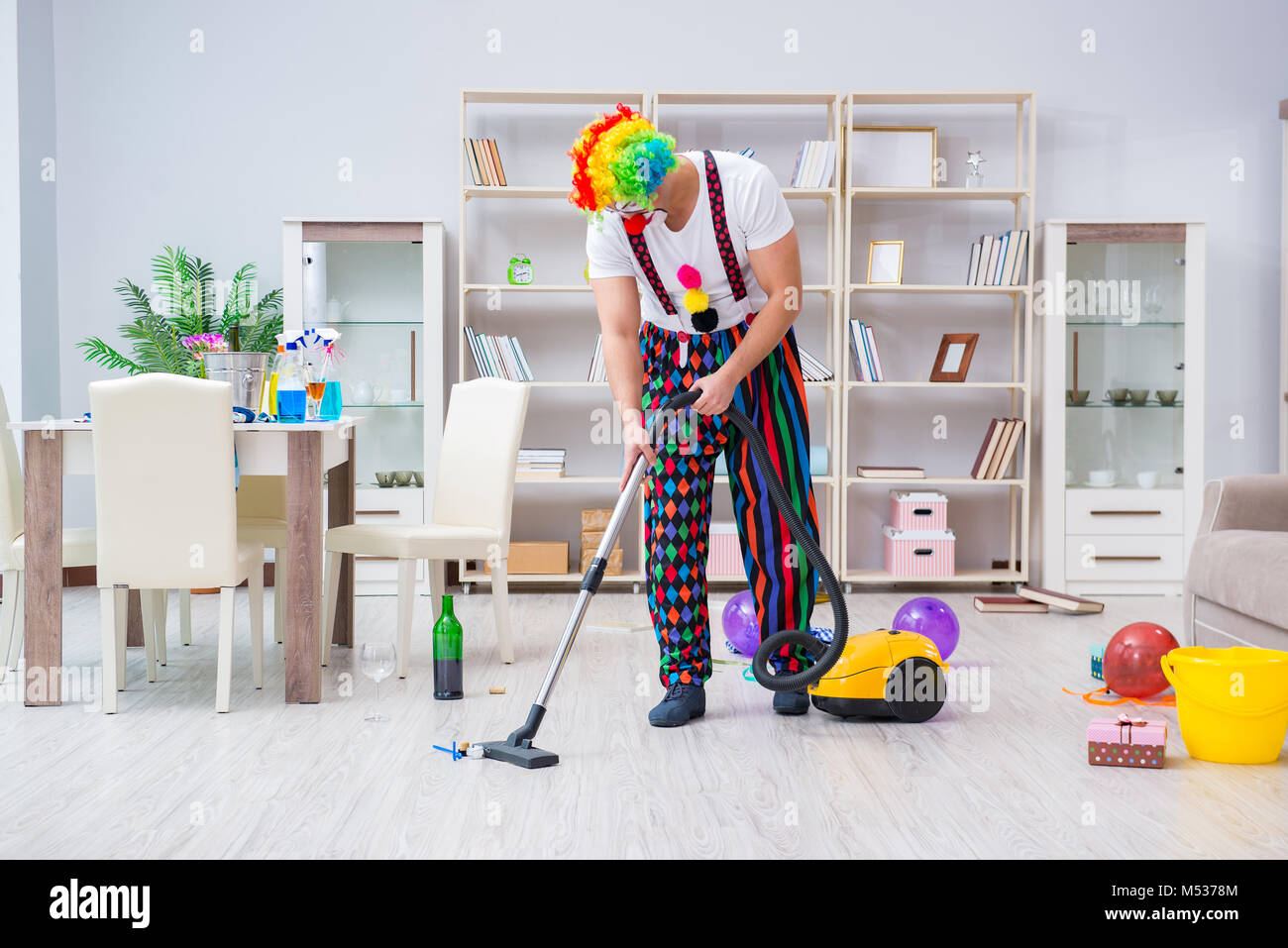 Funny clown doing cleaning at home Stock Photo - Alamy