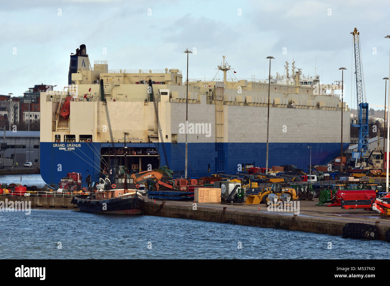 A large car carrier or vehicle carrying ship transporter alongside in ...