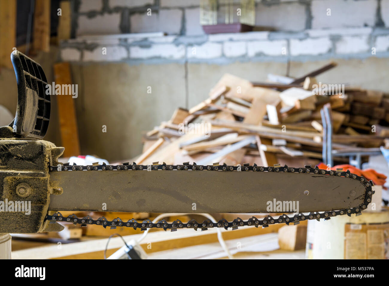 Closeup view of a chainsaw bar and cutting chain at construction site ...