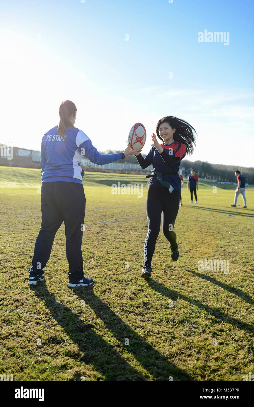 A school PE lesson where the teacher is teaching the college students ...