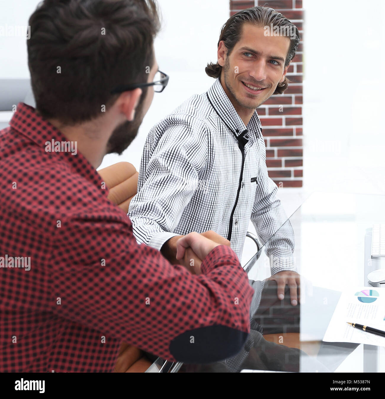 Two men handshake in the office Stock Photo - Alamy