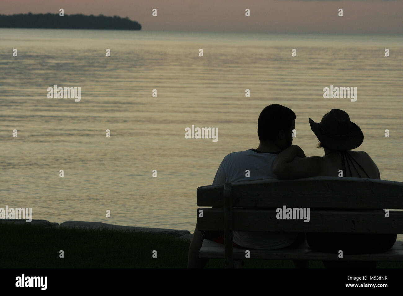 Silhouette of Couple Watching Sunset Stock Photo - Alamy