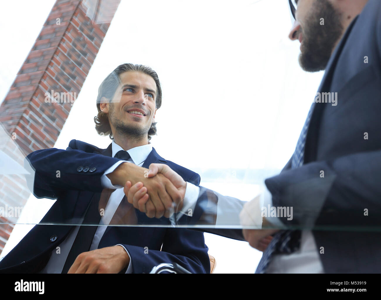 bottom view. confident handshake of business partners Stock Photo - Alamy