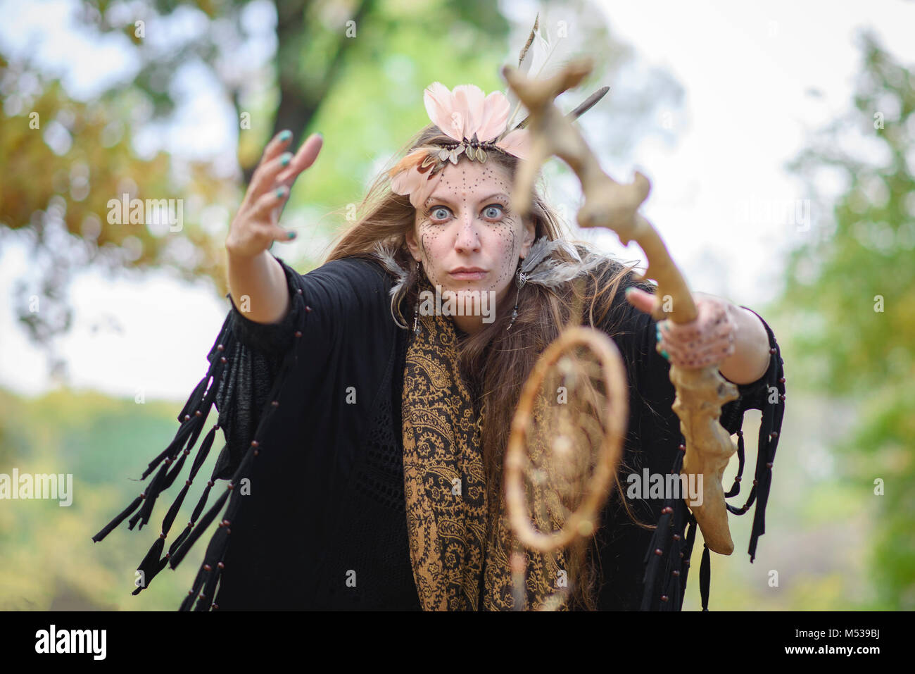 Shaman tribal woman casting ritual magic in nature Stock Photo - Alamy