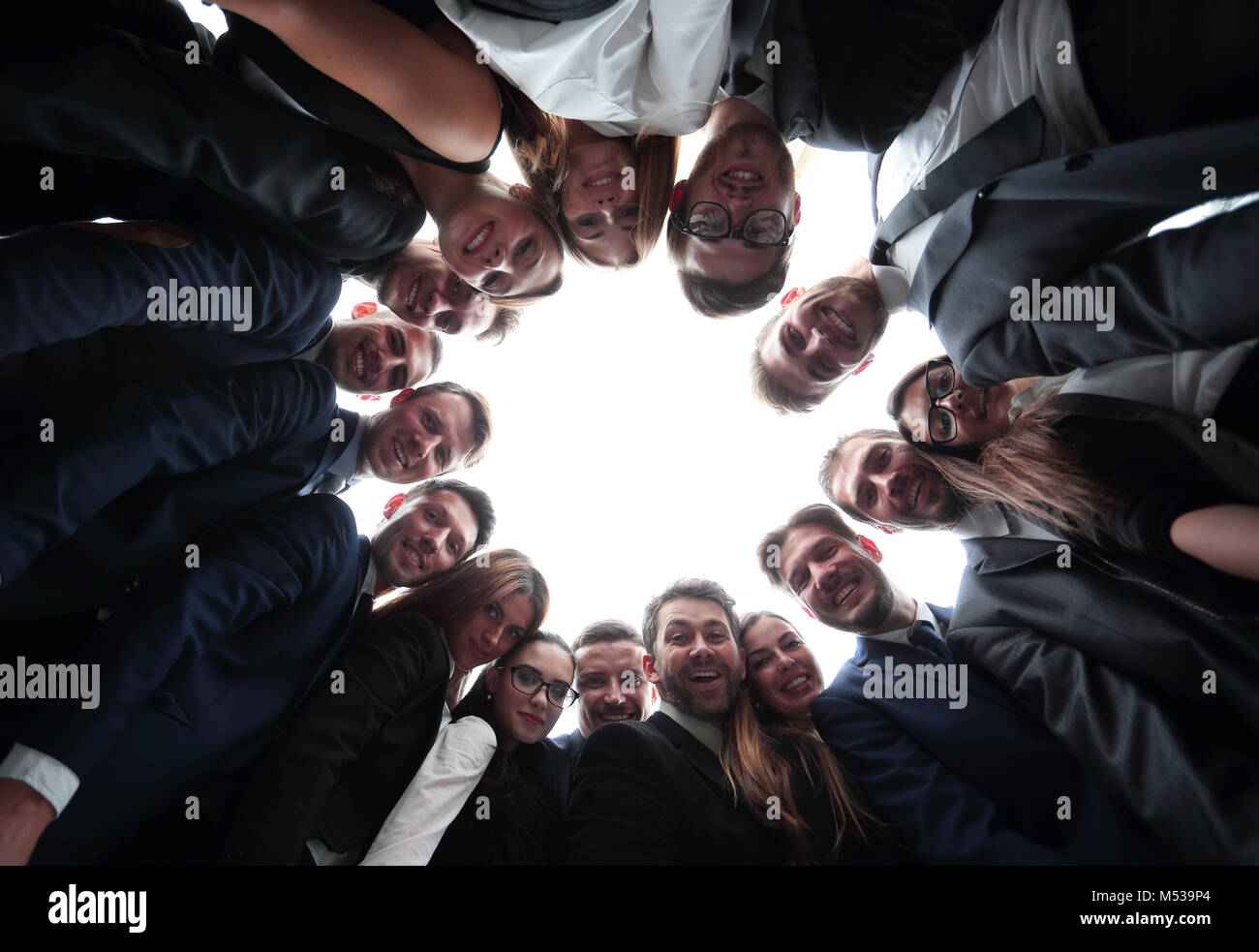 large business team is forming a circle and looking at the camera Stock ...