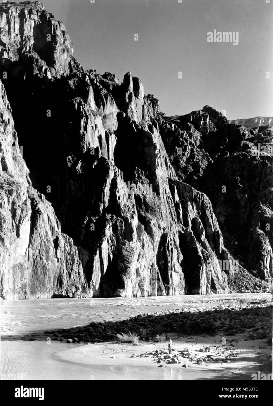 NATURALIST, EDWIN D MCKEE STANDS ON COLORADO RIVER BEACH BELOW KAIBAB ...