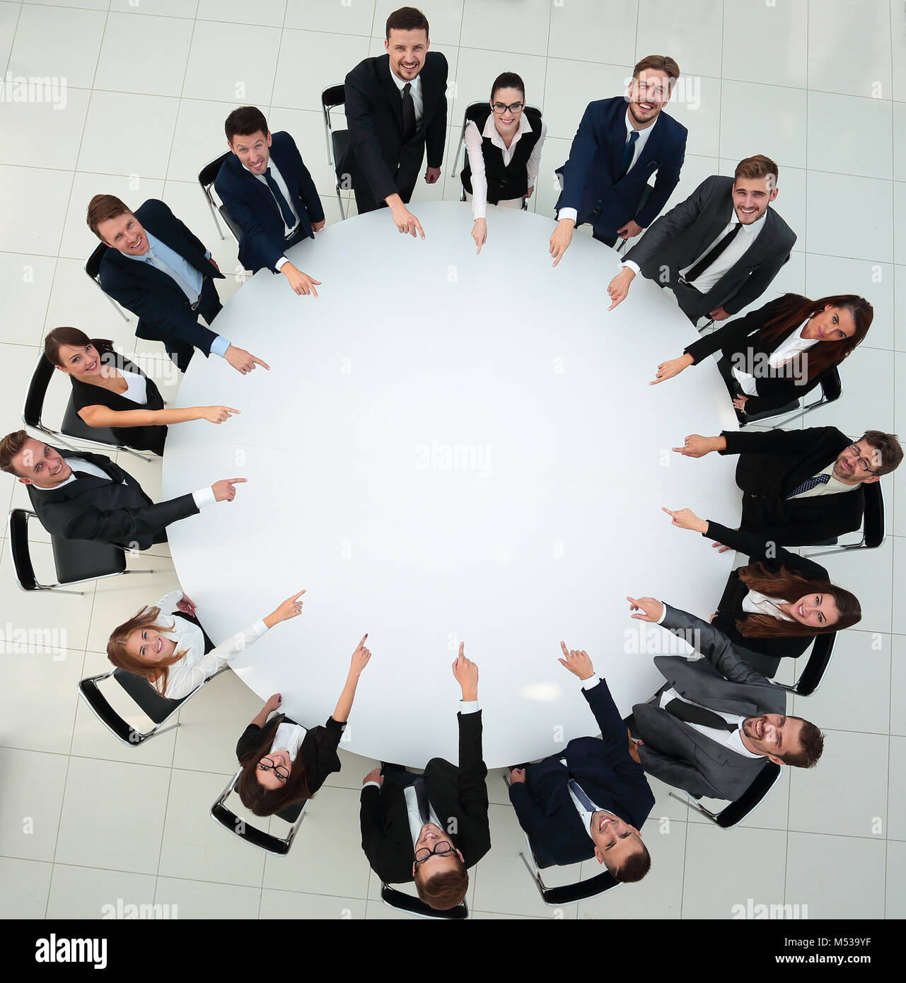 business team indicates the center of the round table Stock Photo - Alamy