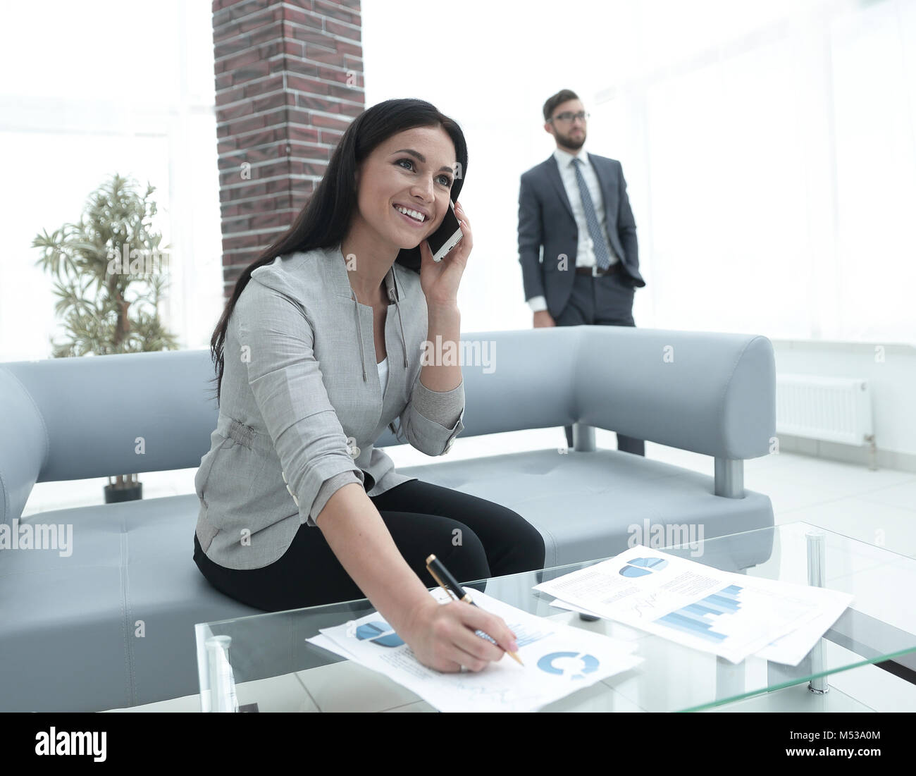 Woman assistant at the workplace in the office Stock Photo - Alamy