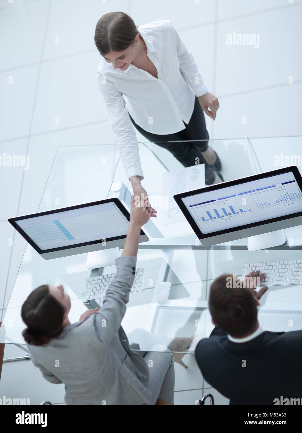 Handshake through monitor hi-res stock photography and images - Alamy