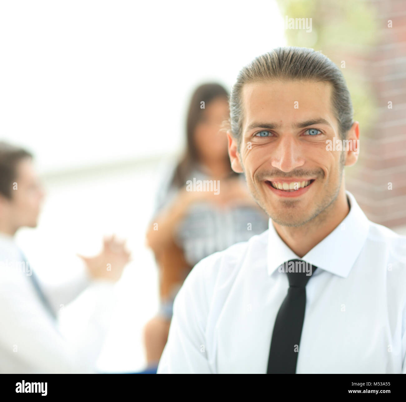 successful young business men on blurred background Stock Photo - Alamy