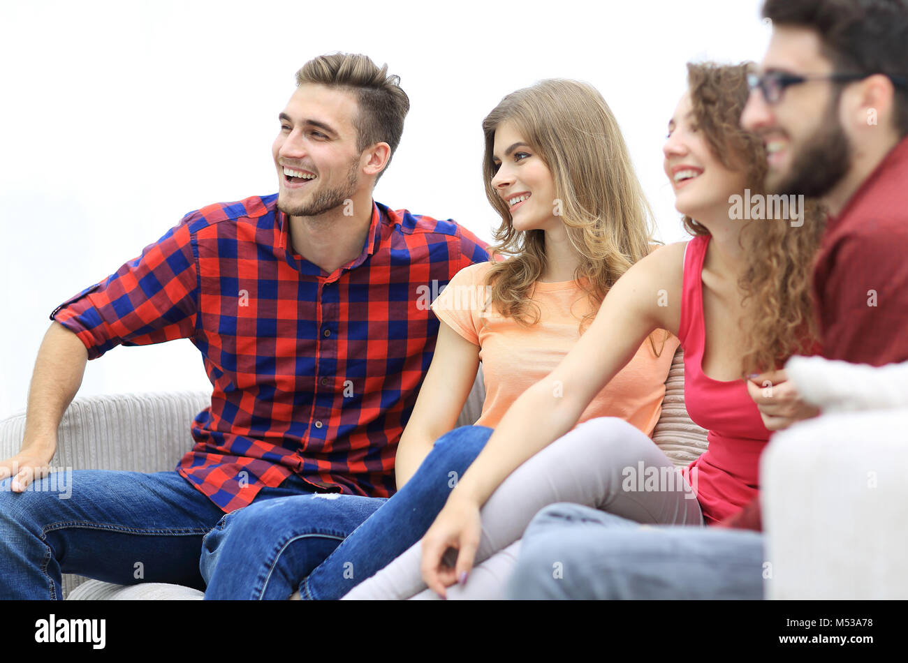 group of cheerful friends sitting on the couch Stock Photo - Alamy