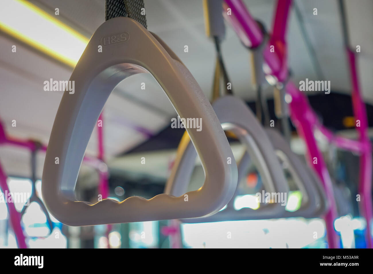 Bus handle for passenger inside public bus Stock Photo - Alamy