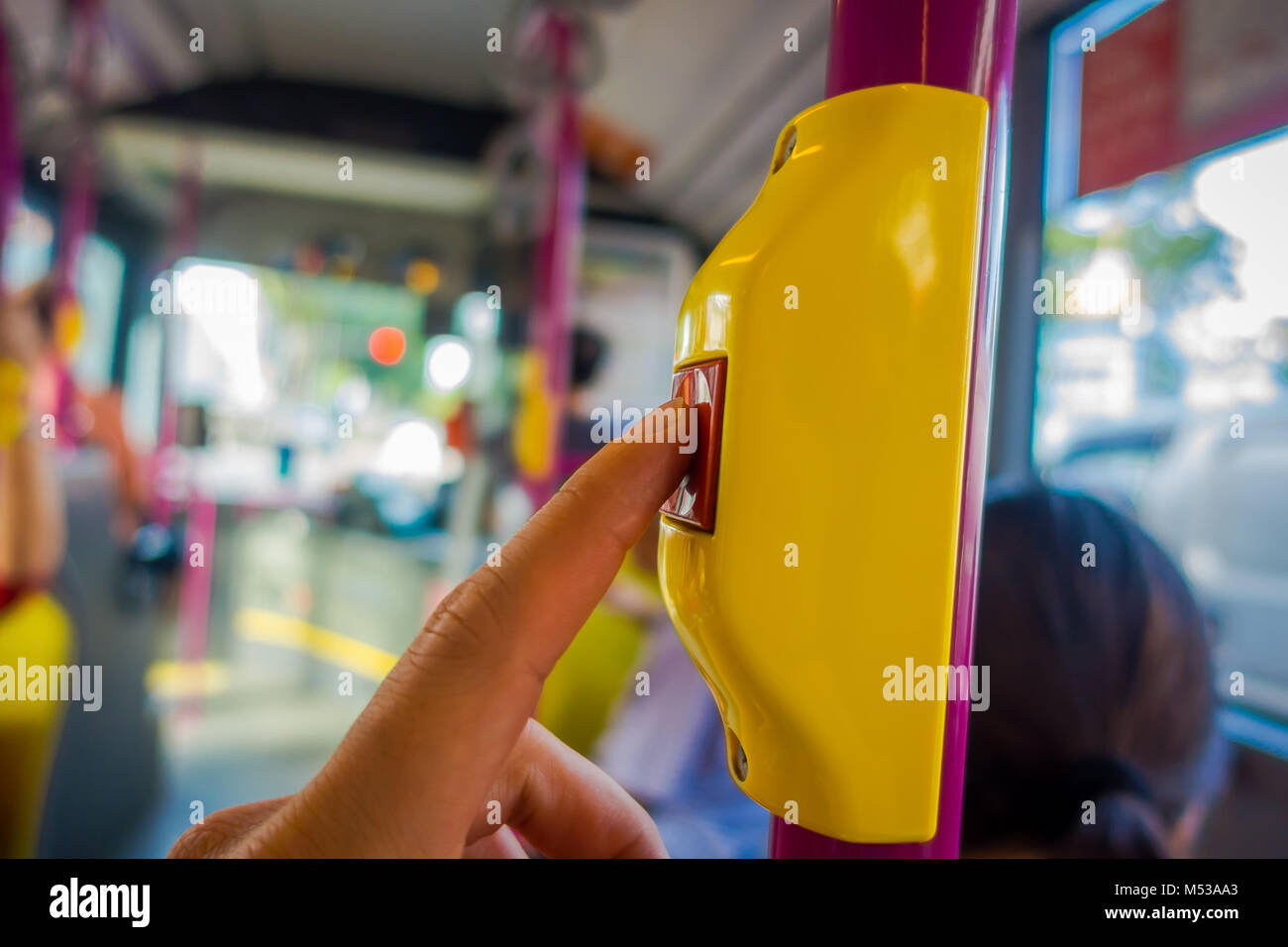 Close up of selective focus of a hand pushing a bus Stop Button inside ...