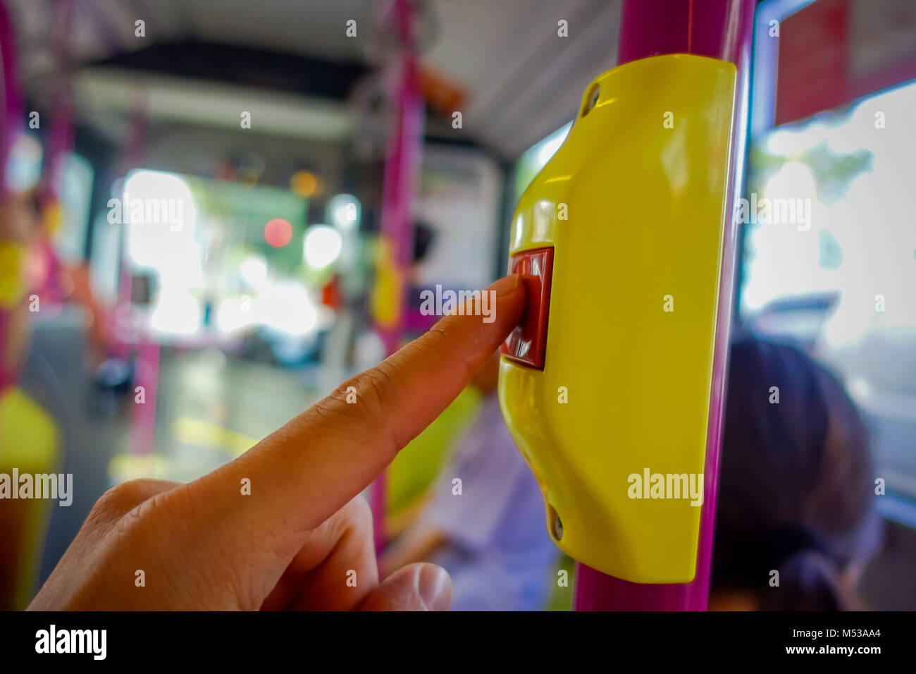 Close up of selective focus of a hand pushing a bus Stop Button inside ...