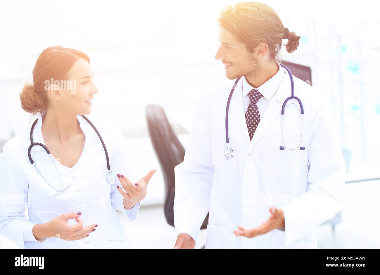 Two Doctors Having Meeting In Hospital Reception Area Stock Photo - Alamy