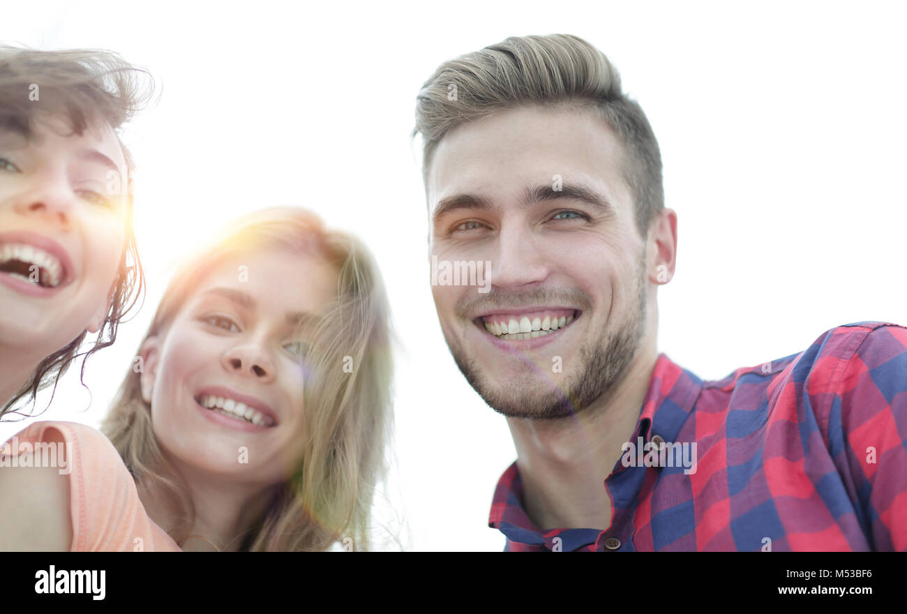 closeup of three young people smiling on white background Stock Photo ...