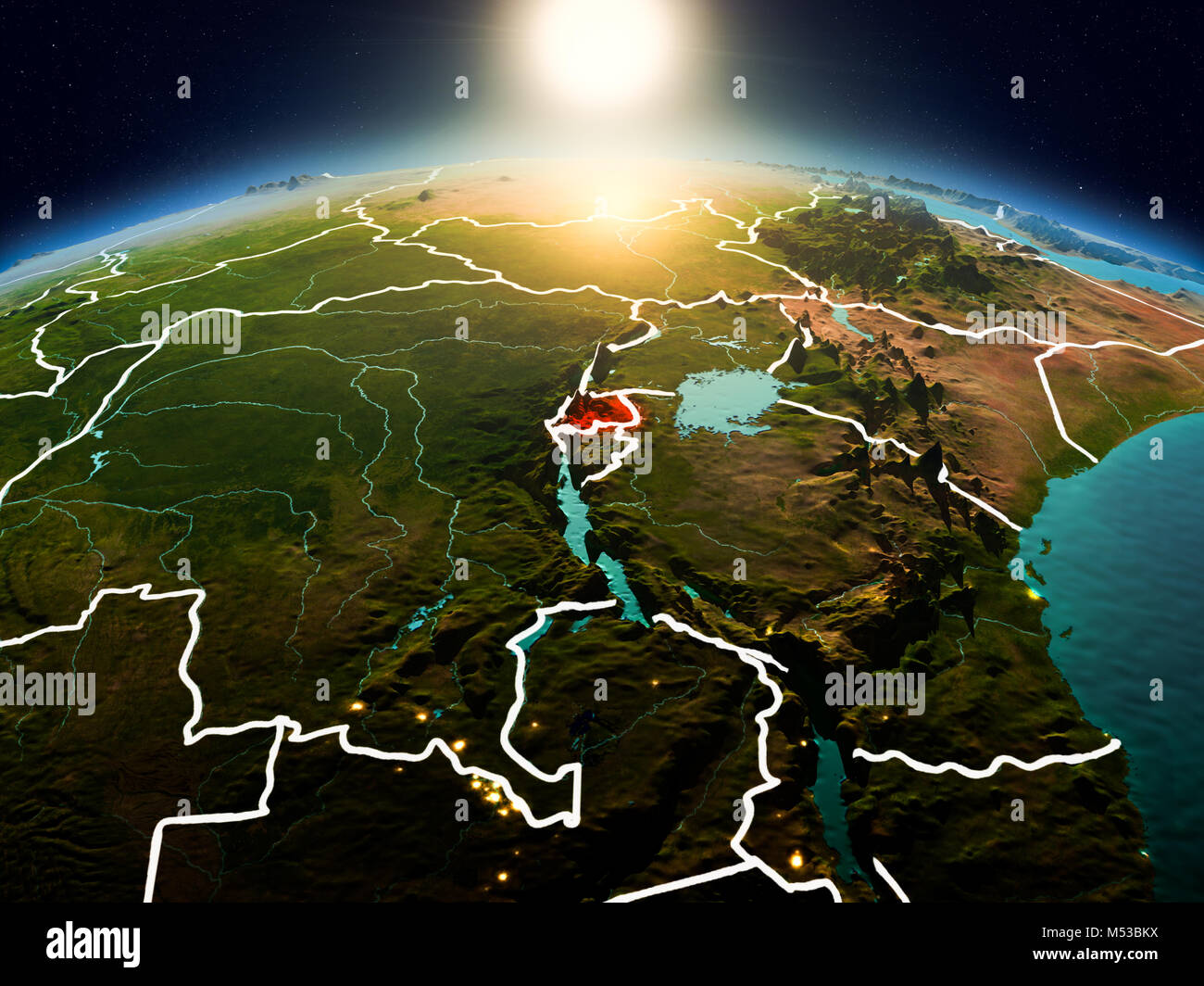 Sunrise above Rwanda highlighted in red on model of planet Earth in space with visible country ...