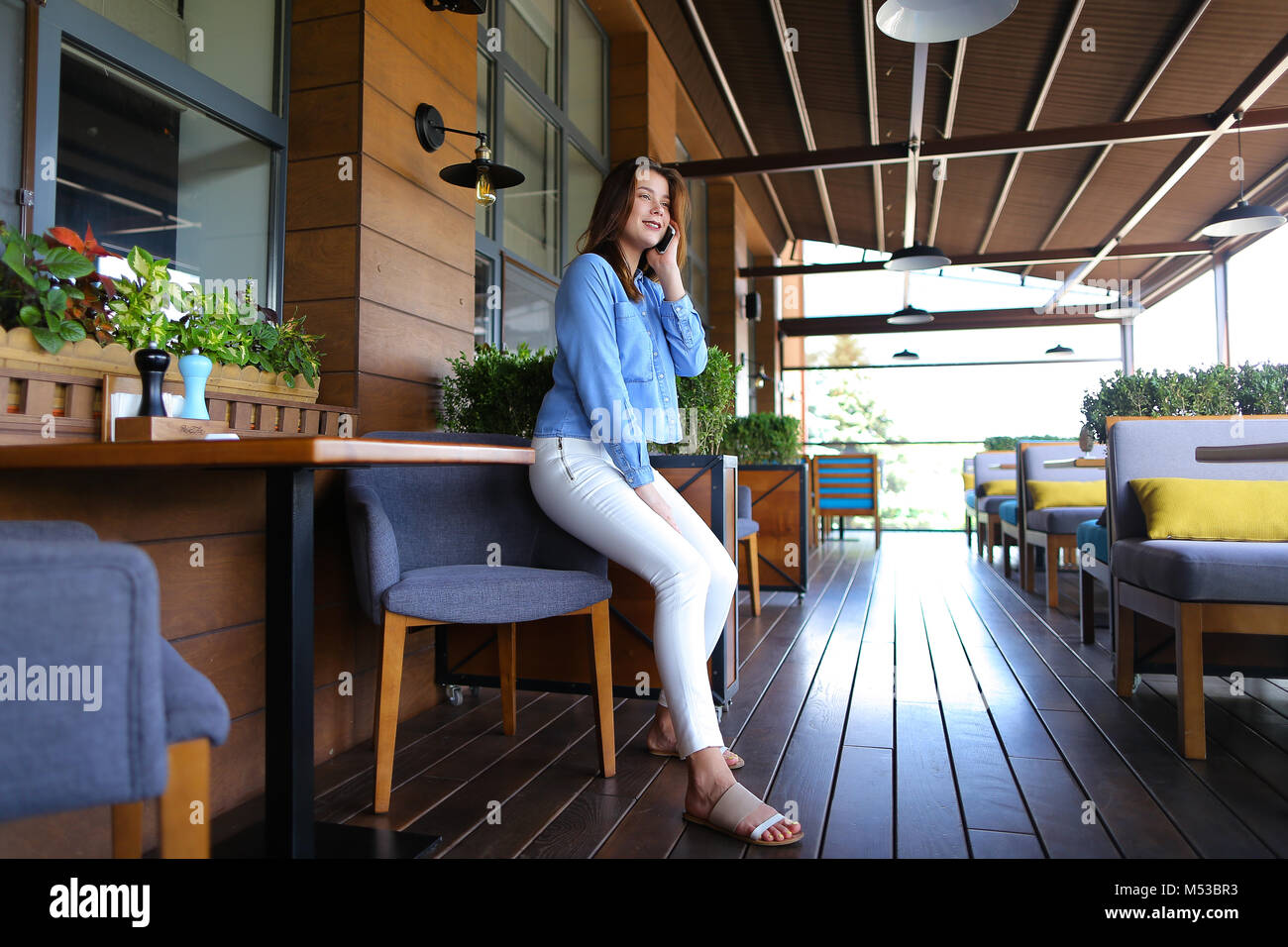 Beautiful female model speaking with photographer by smartphone Stock ...