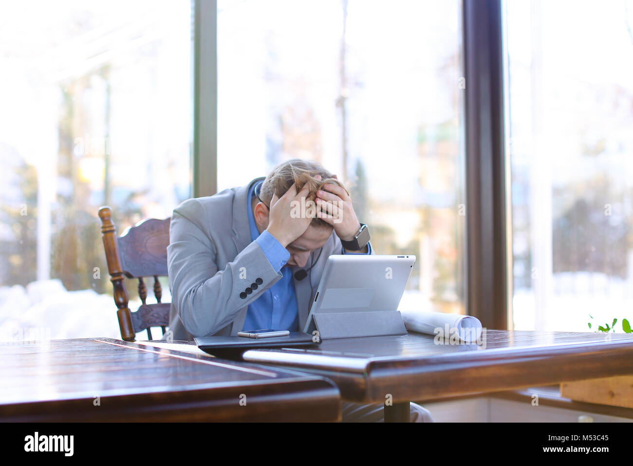 Consultant speaking with client at cafe using tablet and headset Stock ...