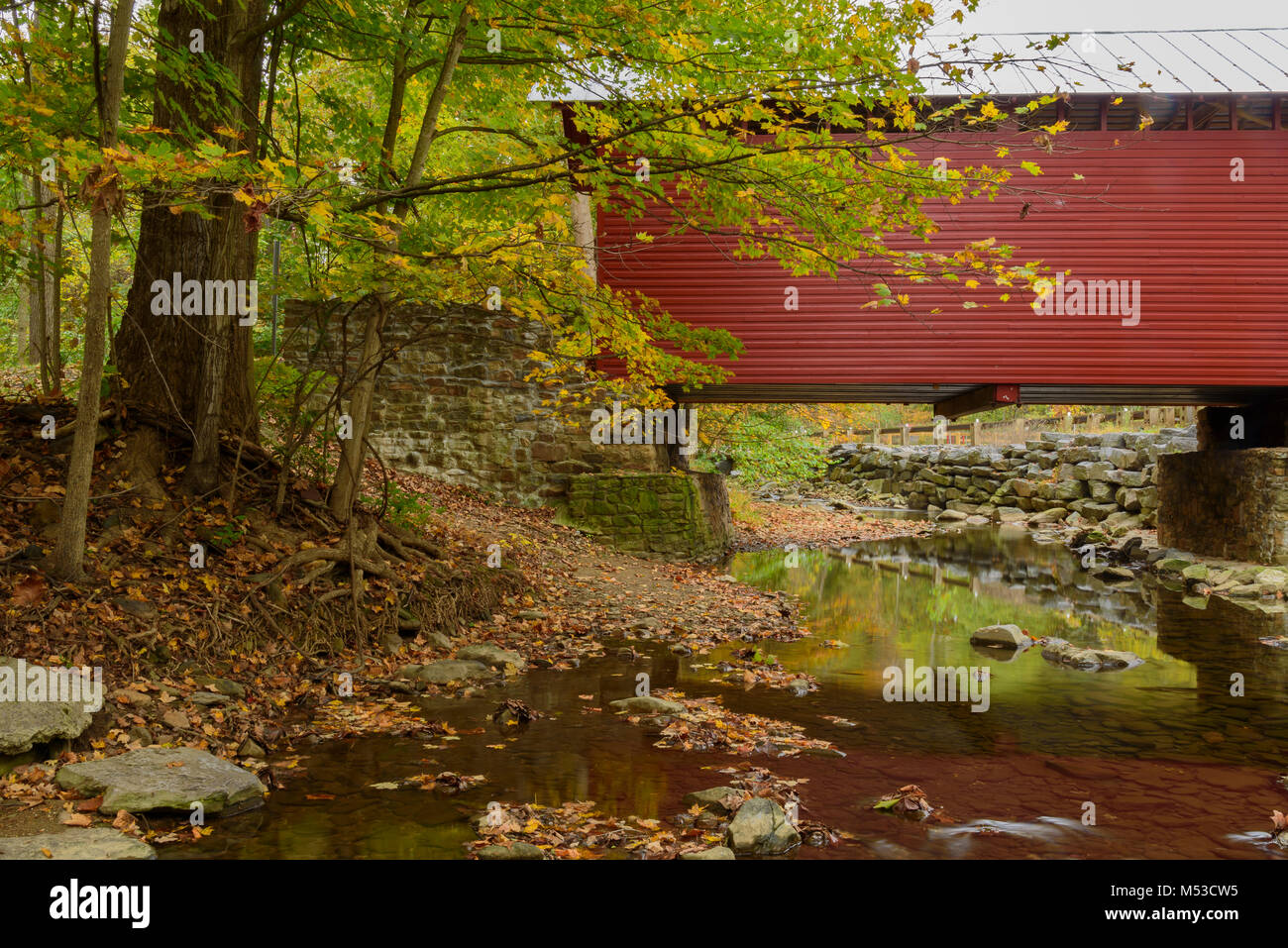 Roddy Road covered bridge is a majestic red color crossing over a ...