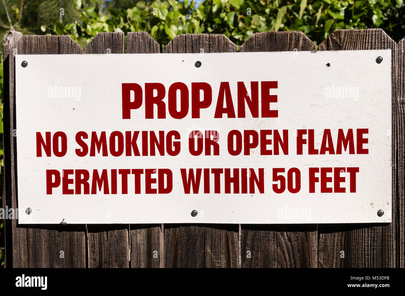 Warning sign near a stationary propane tank warning of the danger Stock ... Warning sign near a stationary propane tank warning of the danger Stock ...