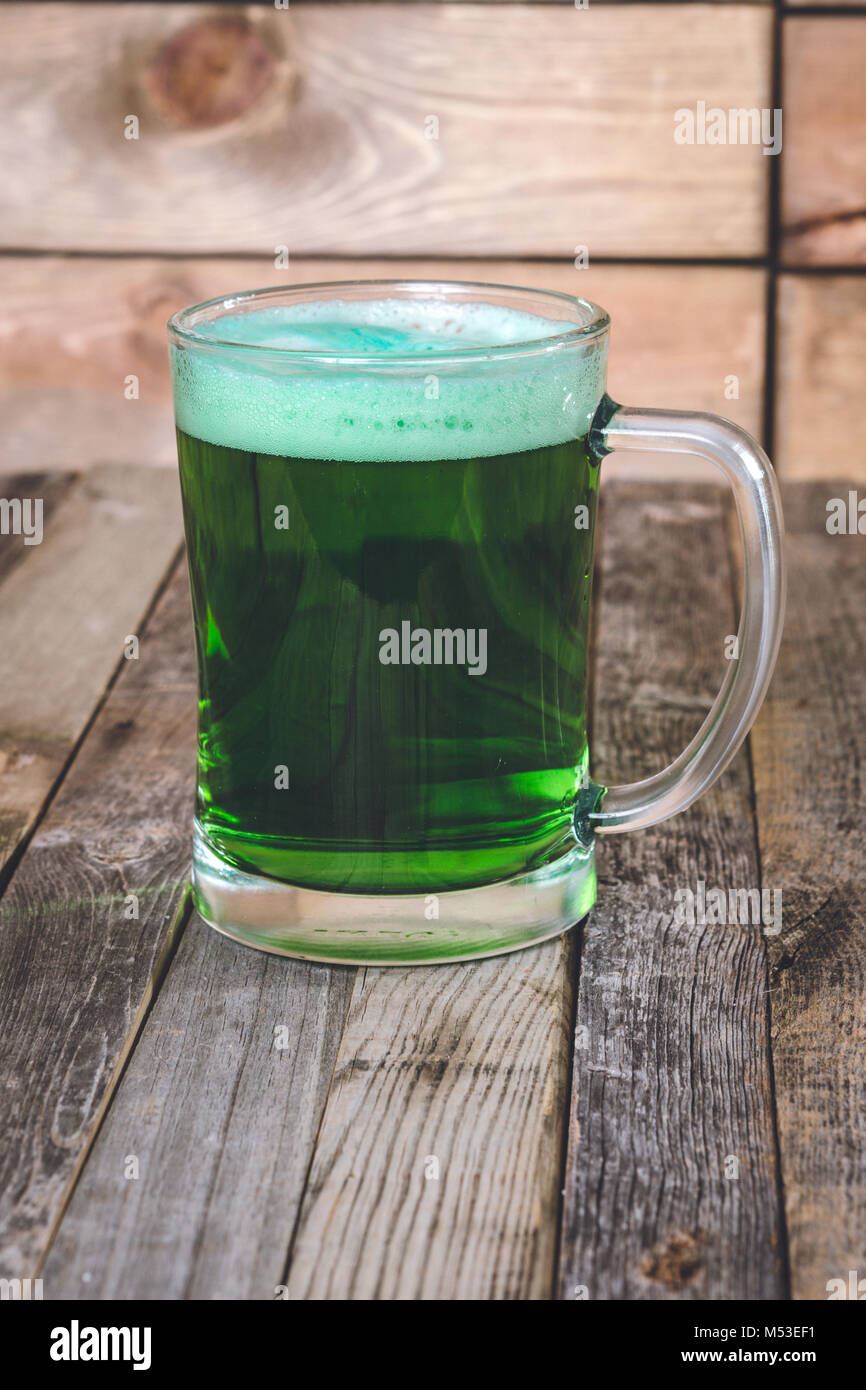 Single mug of green beer on wooden background. Tabletop, front view ...