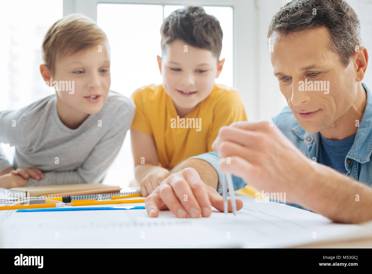 Excited boys watching the process of blueprint creation Stock Photo - Alamy