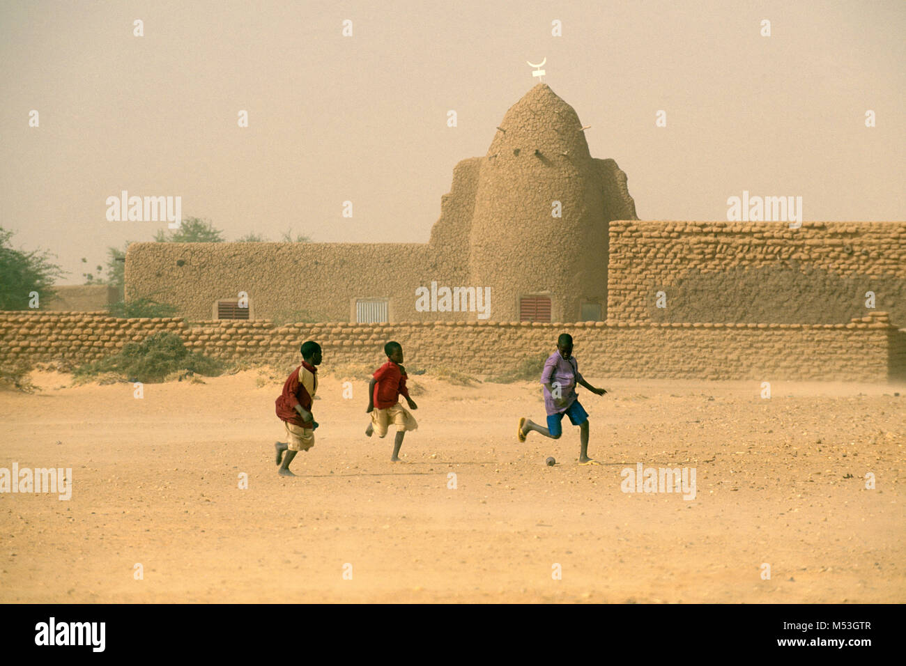 Mali. Bamba, Gao. Sahara desert. Sahel. Children playing football with ...