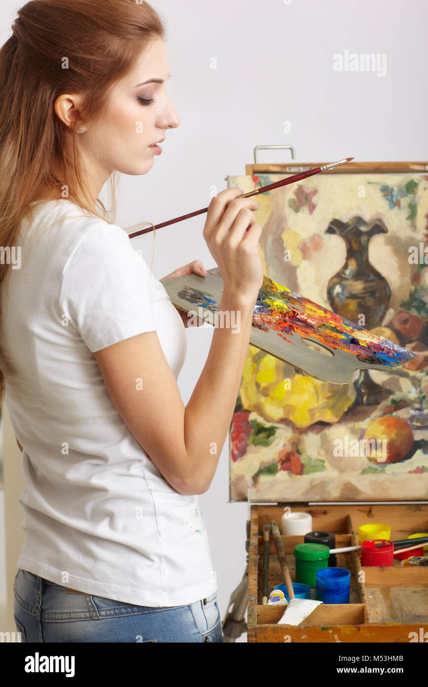 Painter woman with wooden sketchbook and painting Stock Photo - Alamy