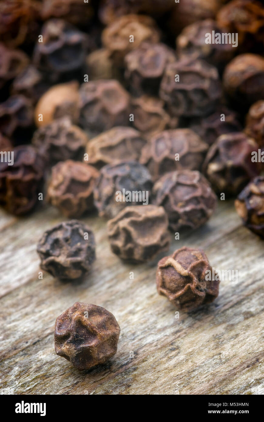 Black pepper (Piper nigrum) on the wooden table Stock Photo - Alamy