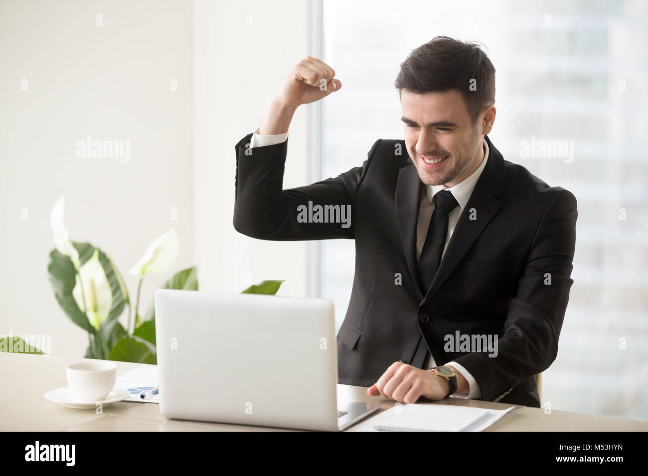 E-commerce businessman celebrating first sale Stock Photo - Alamy
