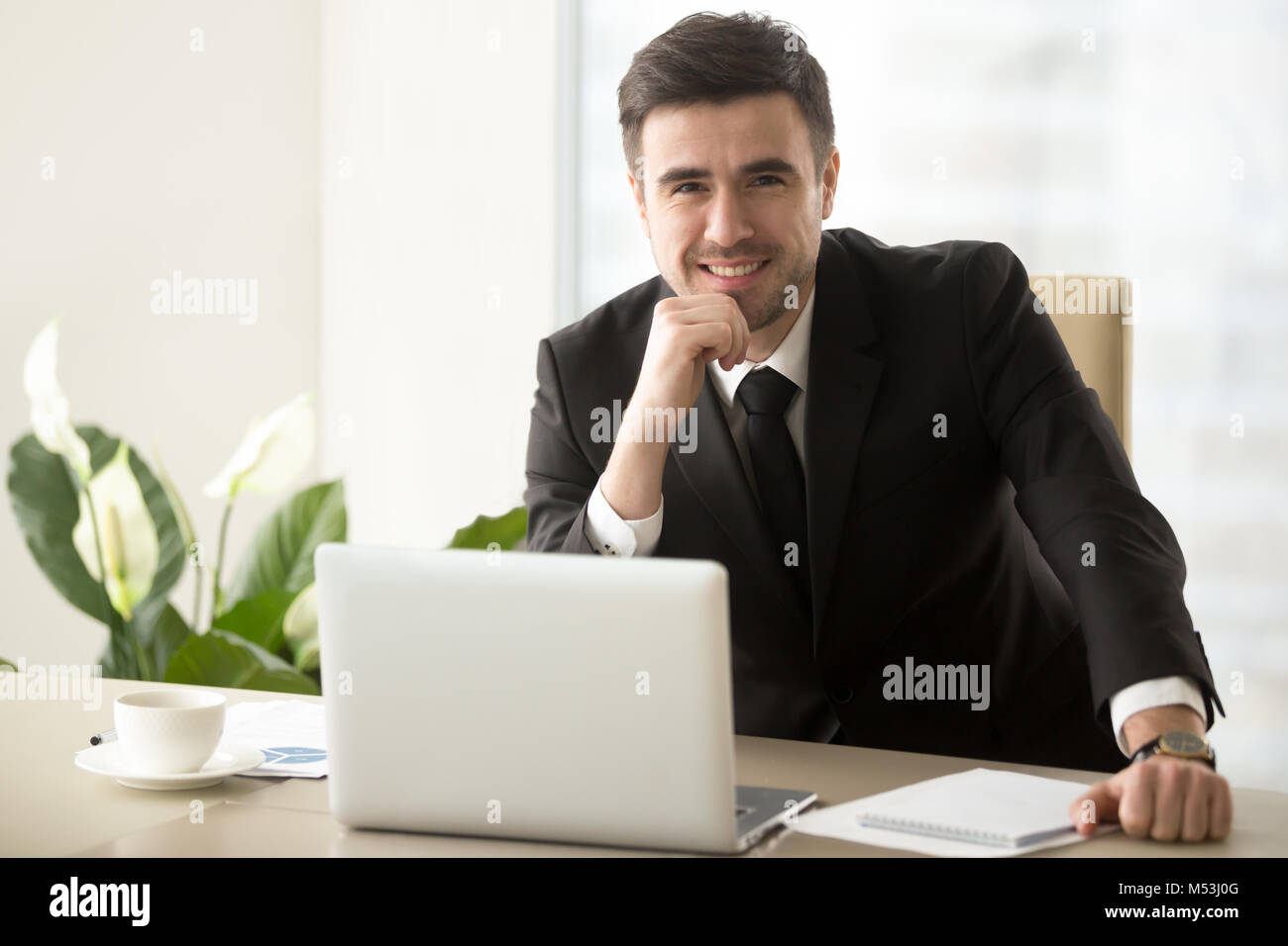 Positive business leader posing at desk in office Stock Photo - Alamy