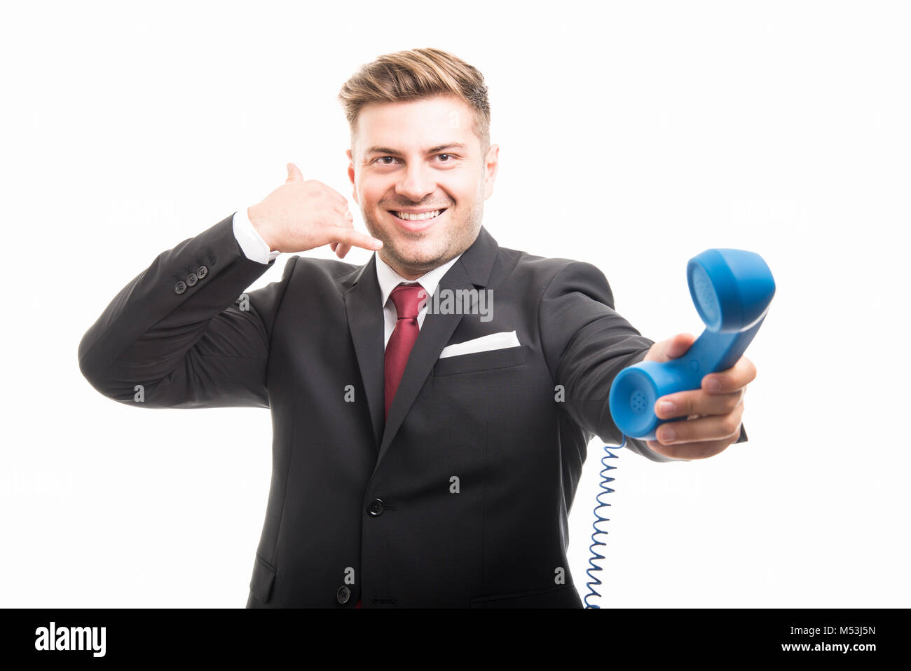 Portrait of business man holding blue telephone receiver showing ...