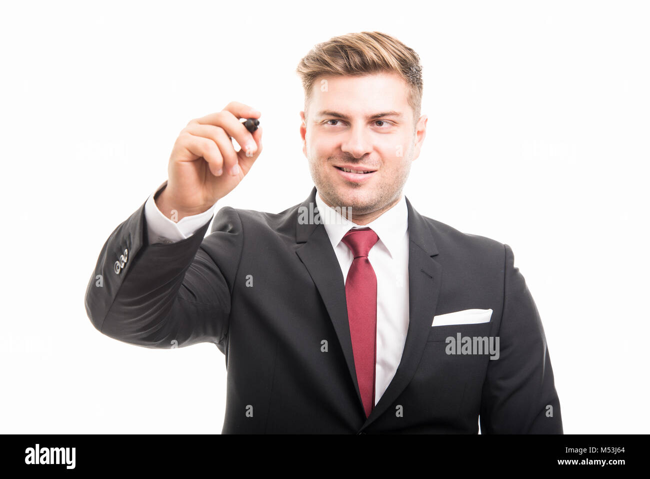 Portrait of business man writing with black marker isolated on white ...