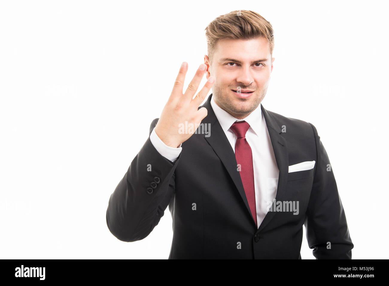 Portrait of handsome corporate business man showing number three ...