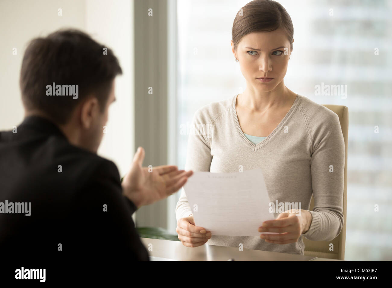 Manager trying to convince doubtful female client Stock Photo - Alamy