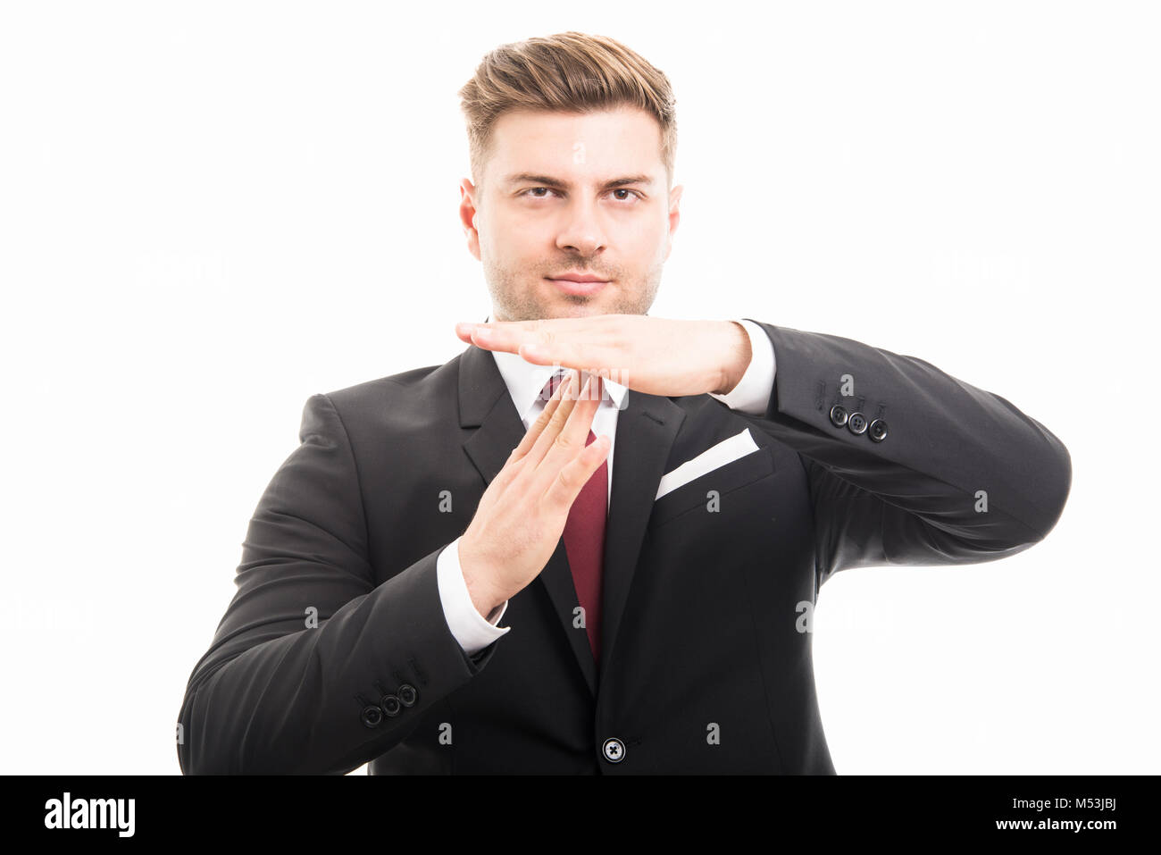 Handsome business man showing time out gesture isolated on white ...
