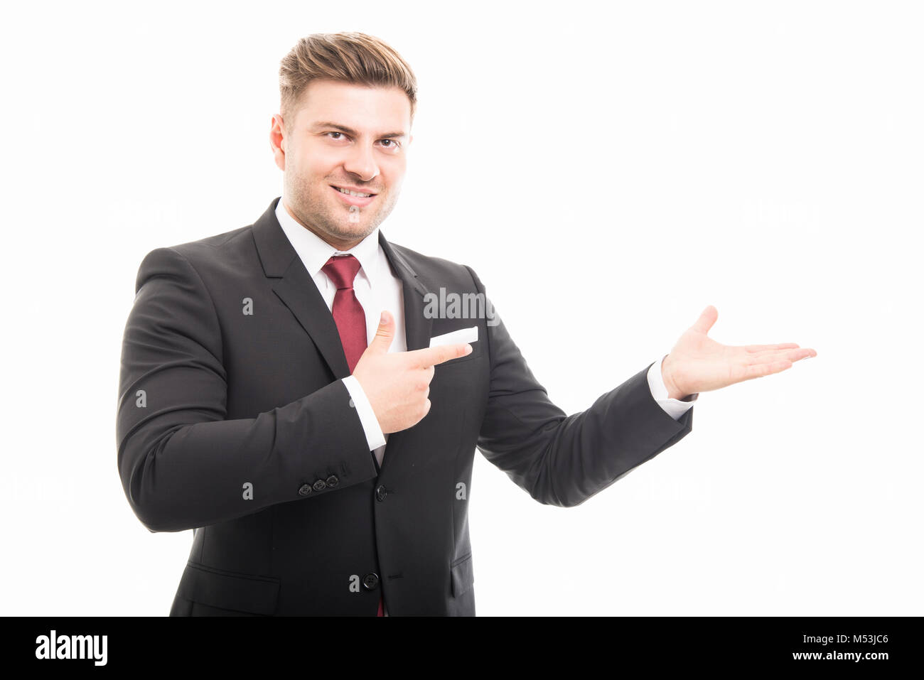 Handsome business man pointing copyspace area isolated on white ...