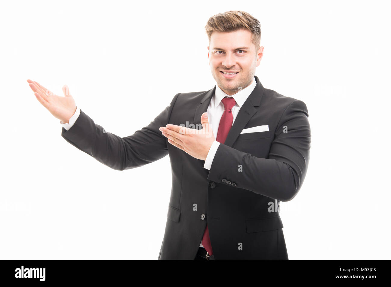 Handsome business man showing copyspace area and smiling isolated on ...